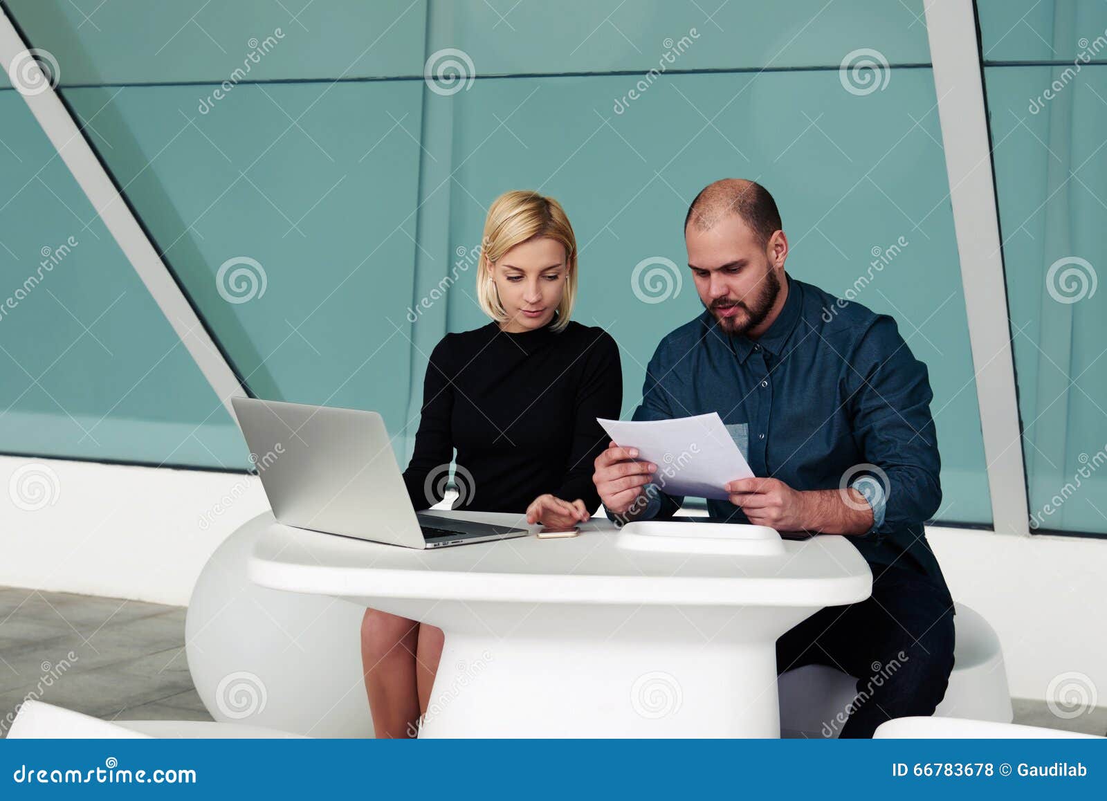 Team of Skilled Leaders Using Laptop Computer and Paper Documents for ...