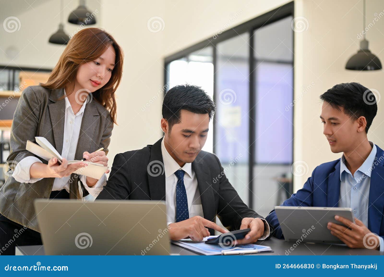 A Team of Smart Asian Financial Analysts Brainstorming, Discussing Plan and Working Together ...