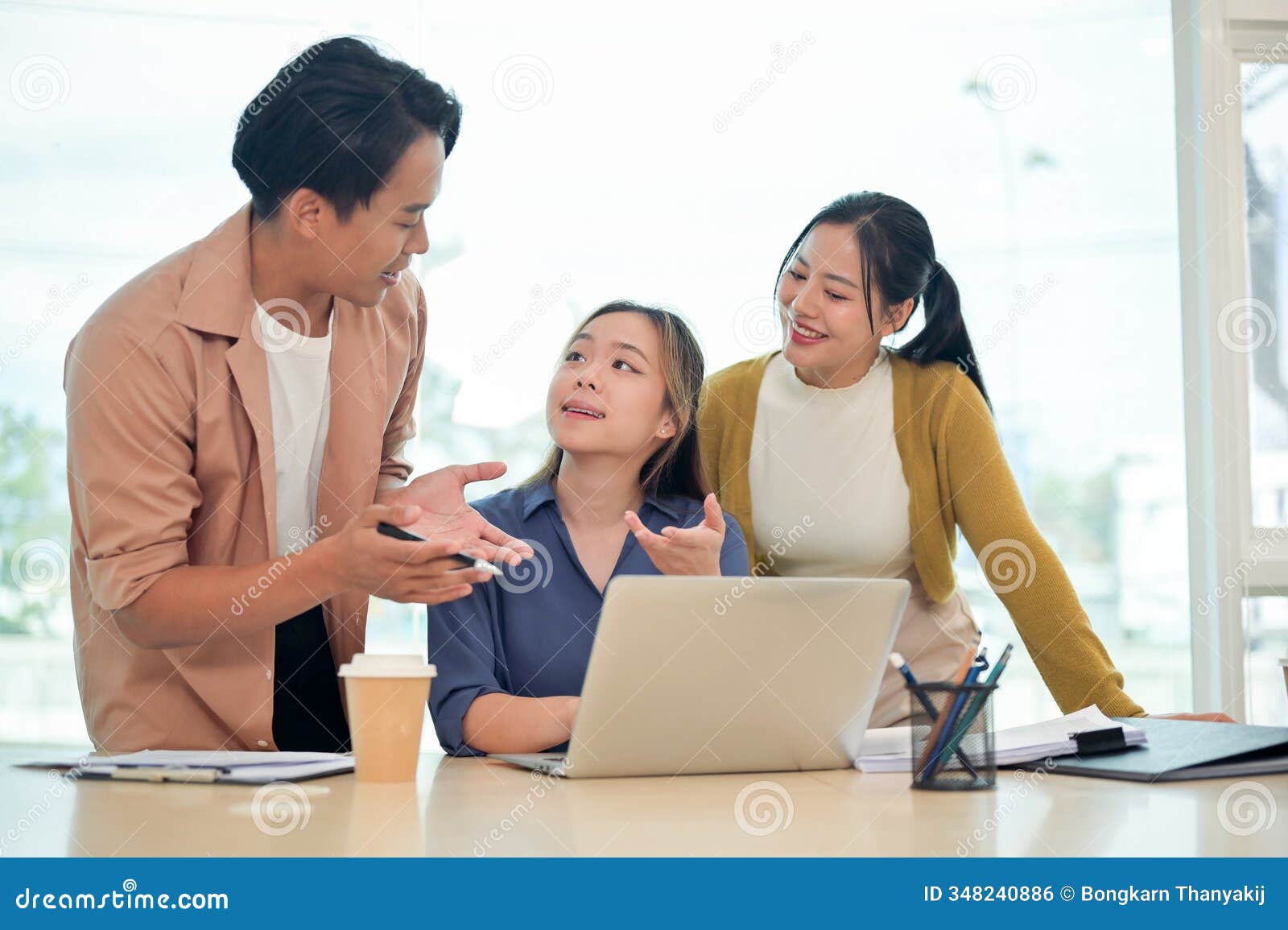 A Team of Smart Young Employees Focused on Discussing Work, Sharing ...