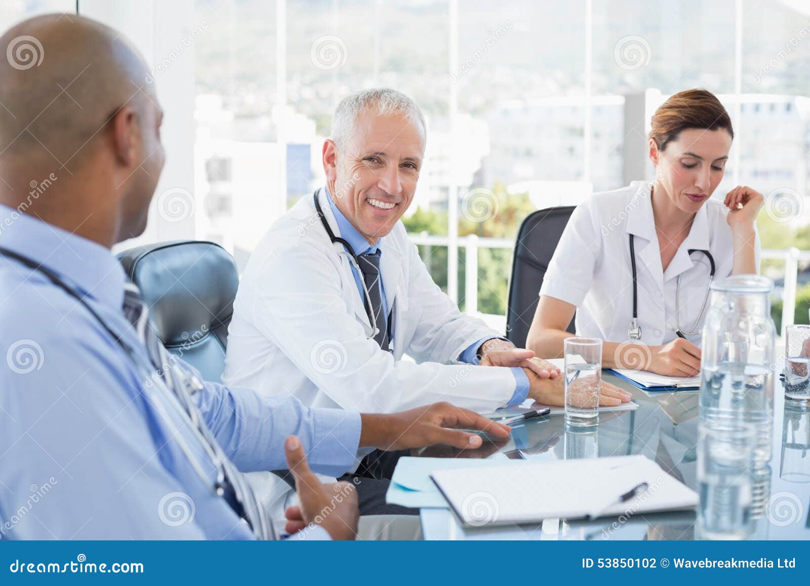Team of Smiling Doctors Having a Meeting Stock Photo - Image of male ...