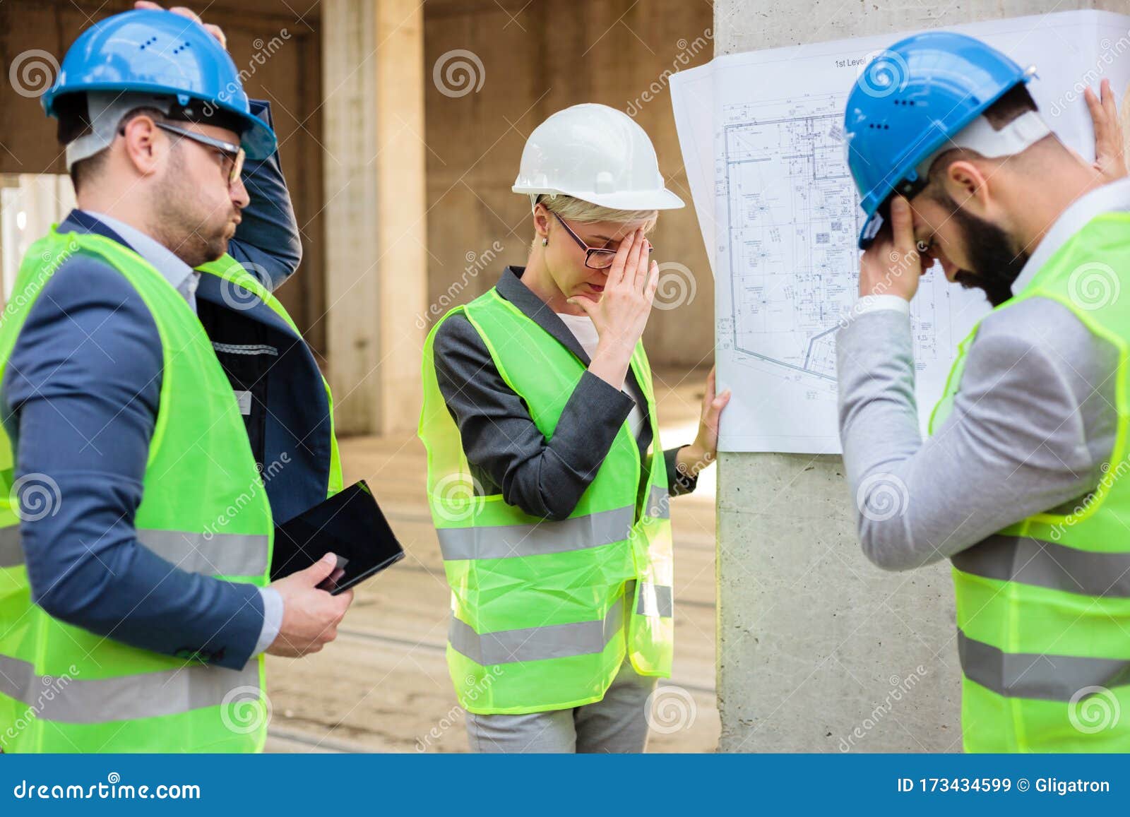 Team of Successful Young Engineers Finding Problems in Blueprints ...