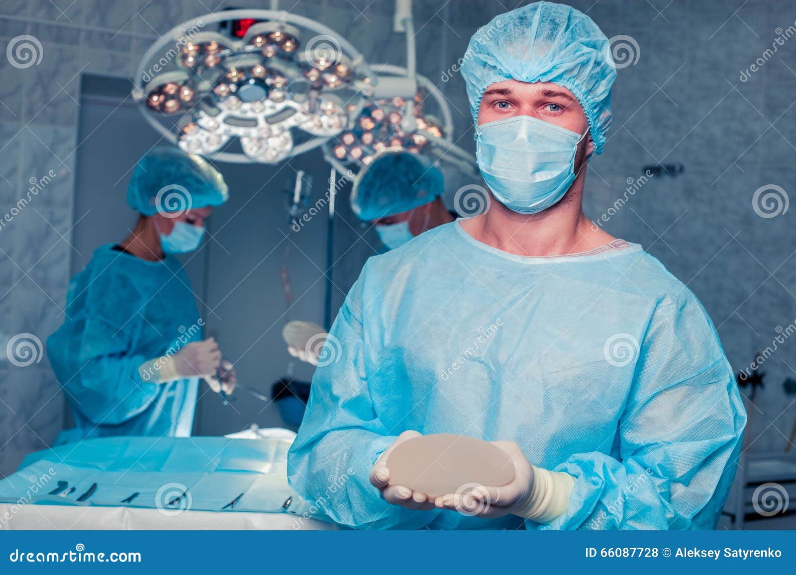 Team Surgeon At Work In Operating Room. Surgical Light In The Operating ...