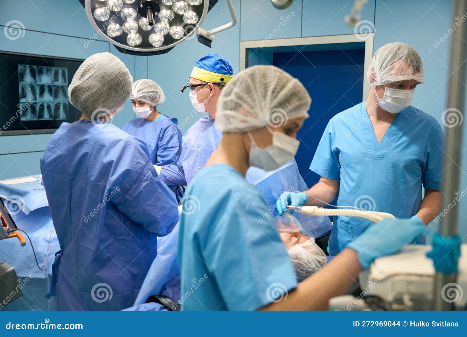 Team of Surgeons Performs an Operation, a Patient Under Anesthesia ...