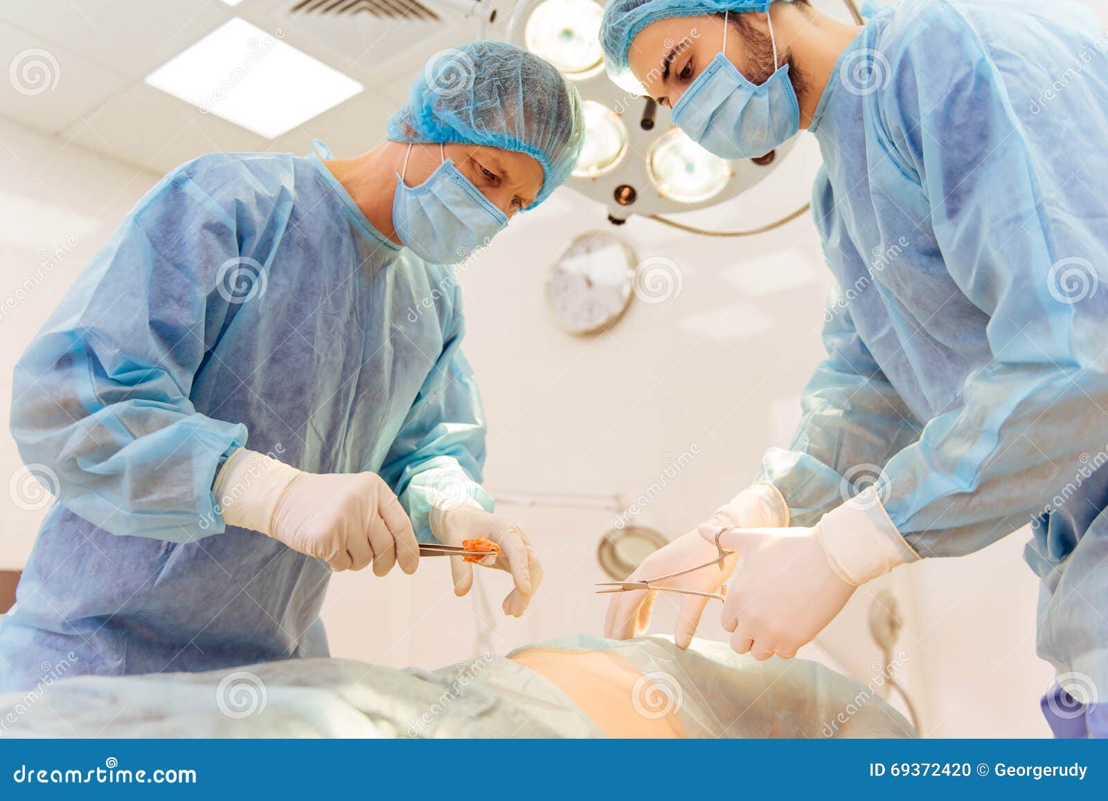 Team surgeons at work stock photo. Image of middle, operating - 69372420