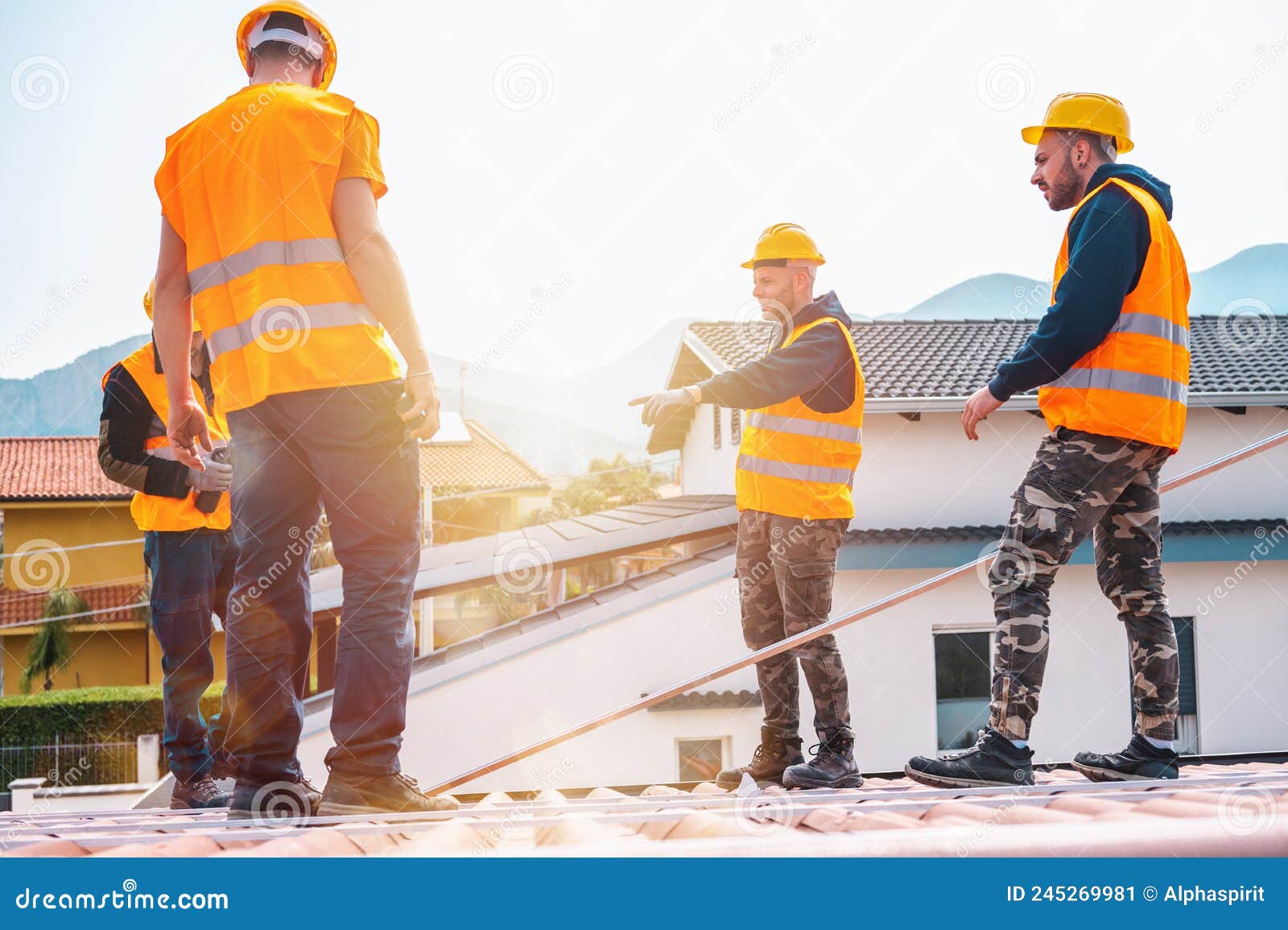 Team Of Technical Workers Work On The Roof Of A House Royalty-Free ...