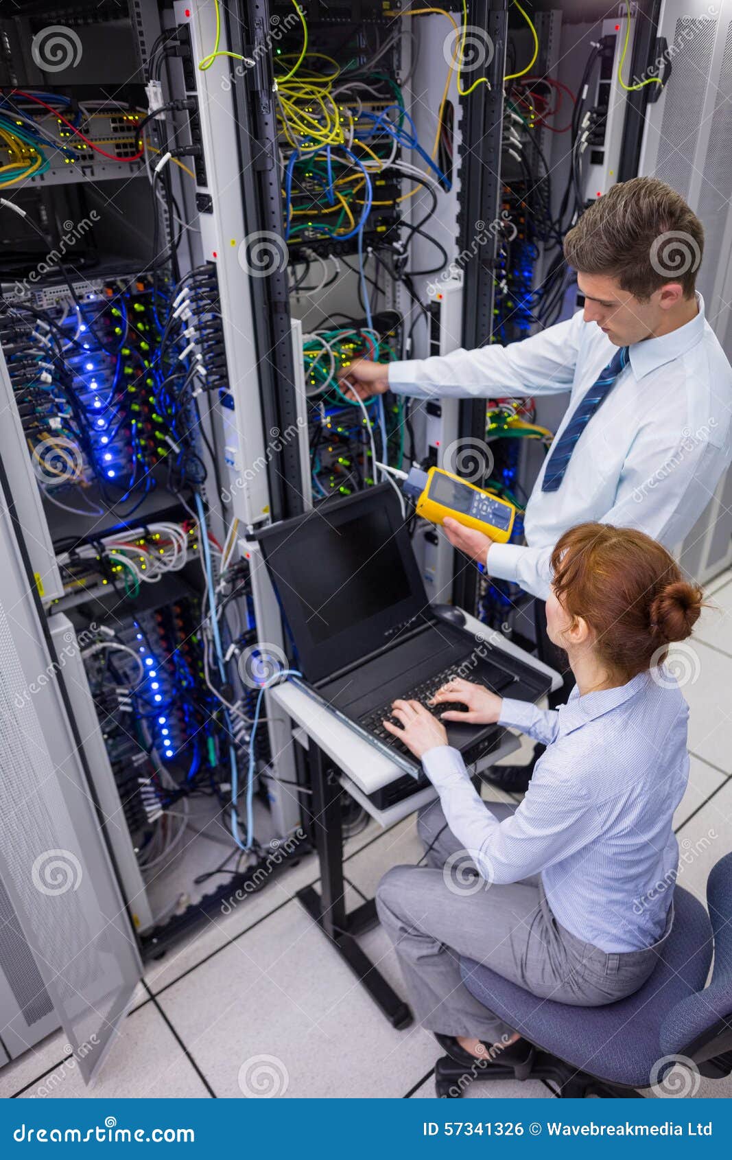 Team of Technicians Using Digital Cable Analyser on Servers Stock Photo ...