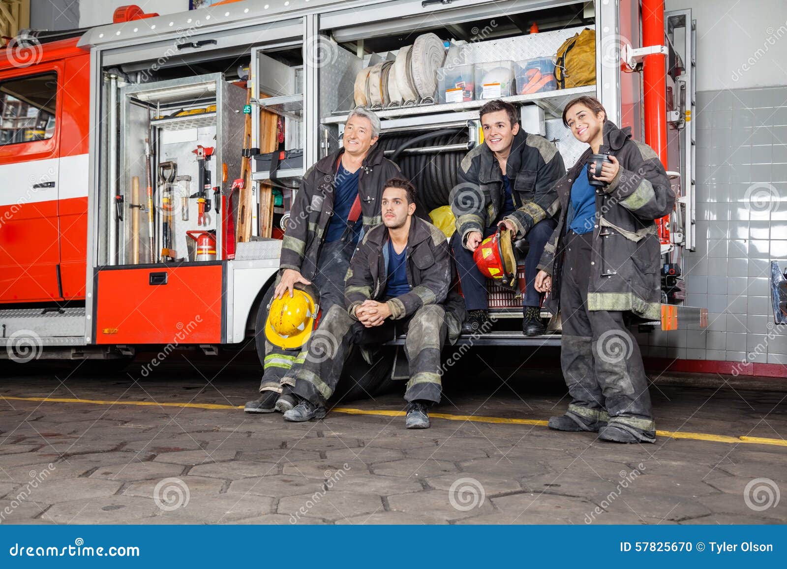 Team of Thoughtful Firefighters by Firetruck Stock Photo - Image of ...
