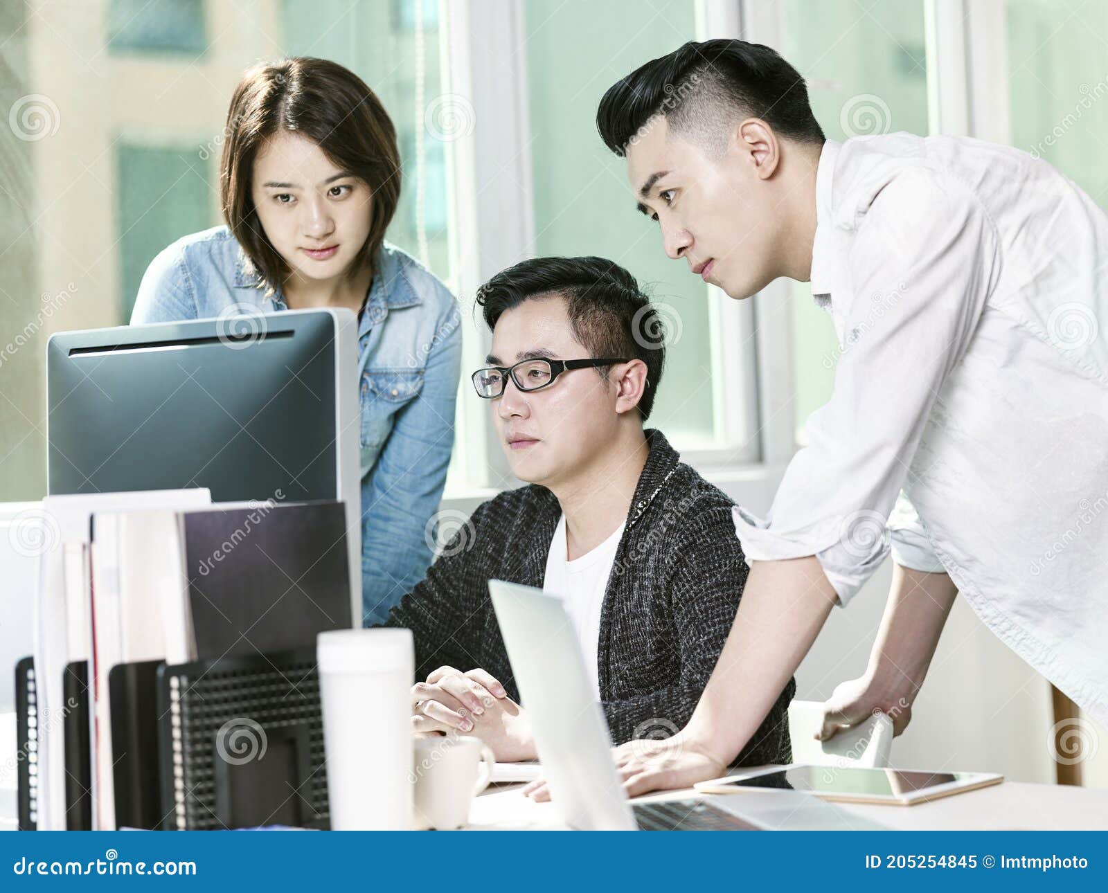 Team of Three Asian Business People Working Together in Office Stock ...