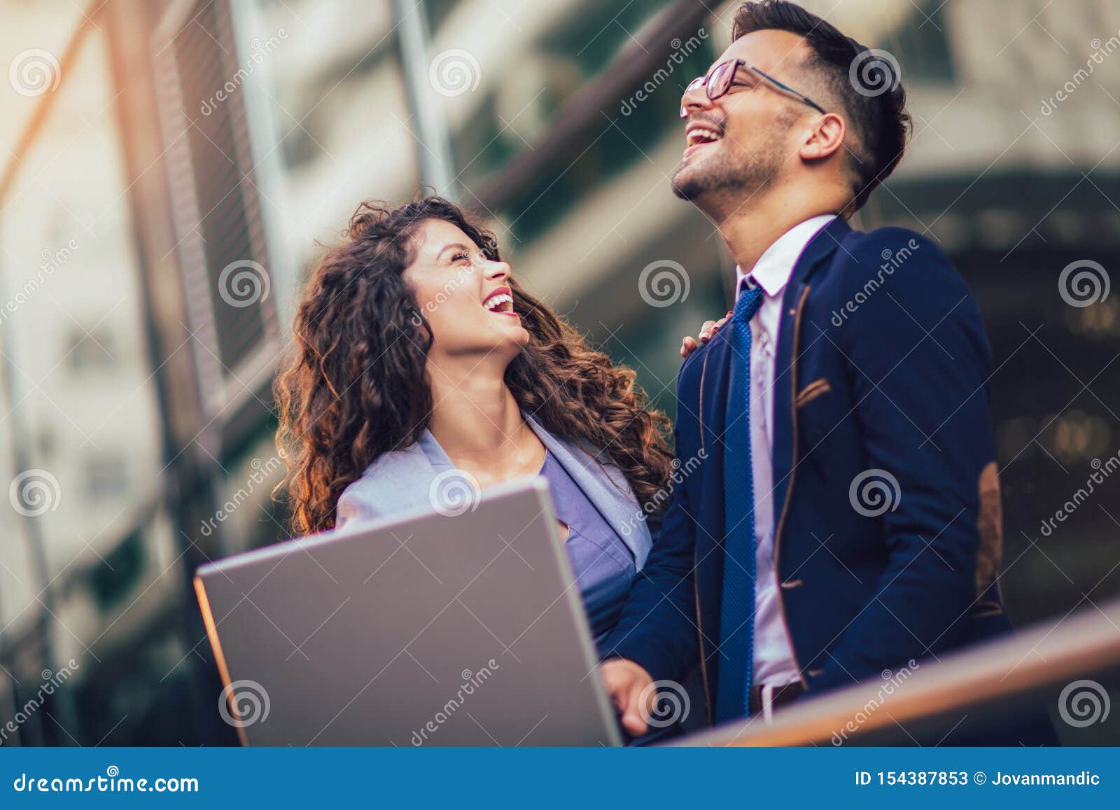 Two Business People Working Together Outdoors Using Laptop Stock Image ...