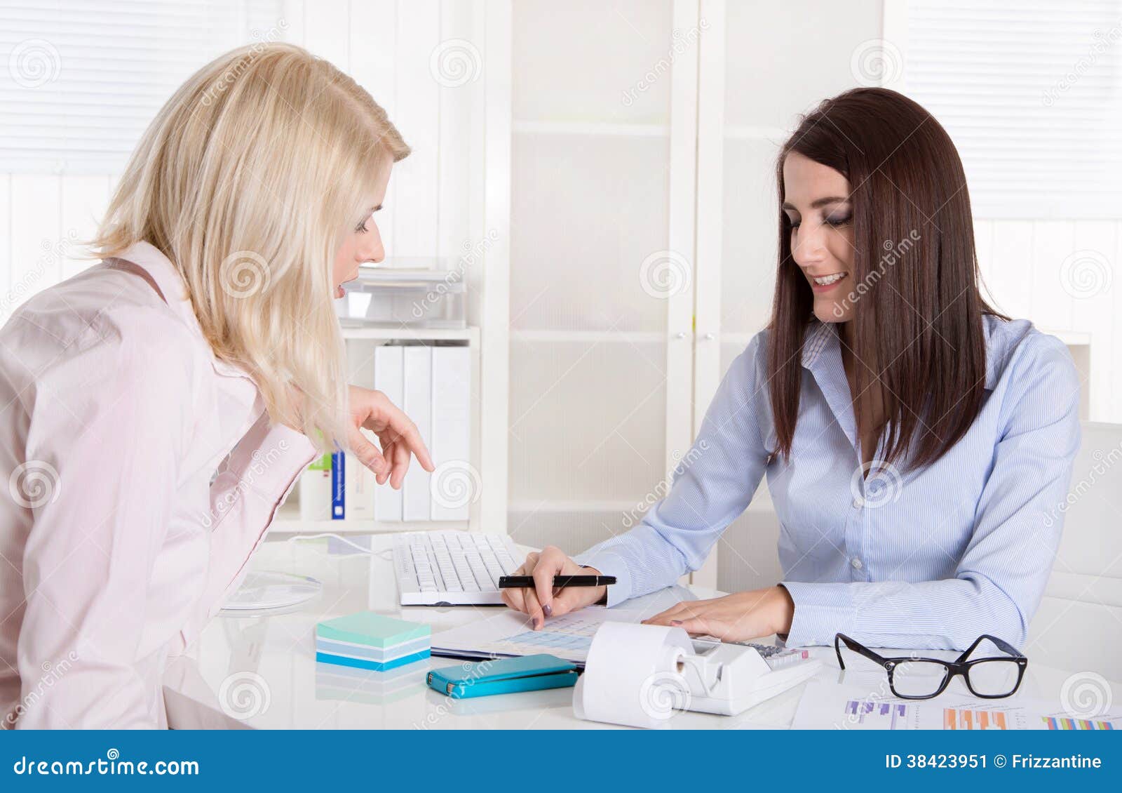 Team: Two Young Beautiful Female Employees Working Together. Stock ...