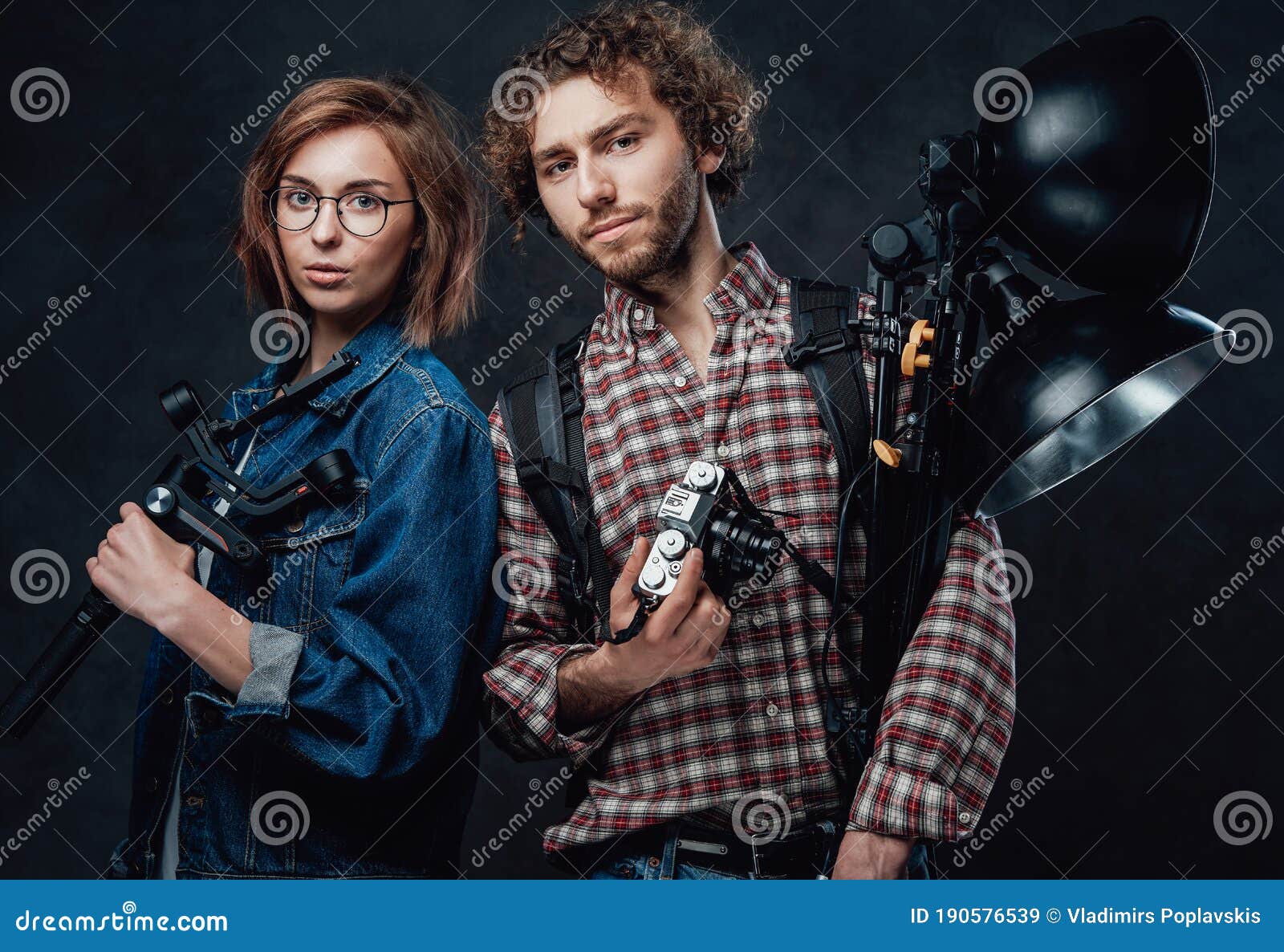 The Team of Two Young Photographers Holds a Digital Camera and Lighting ...
