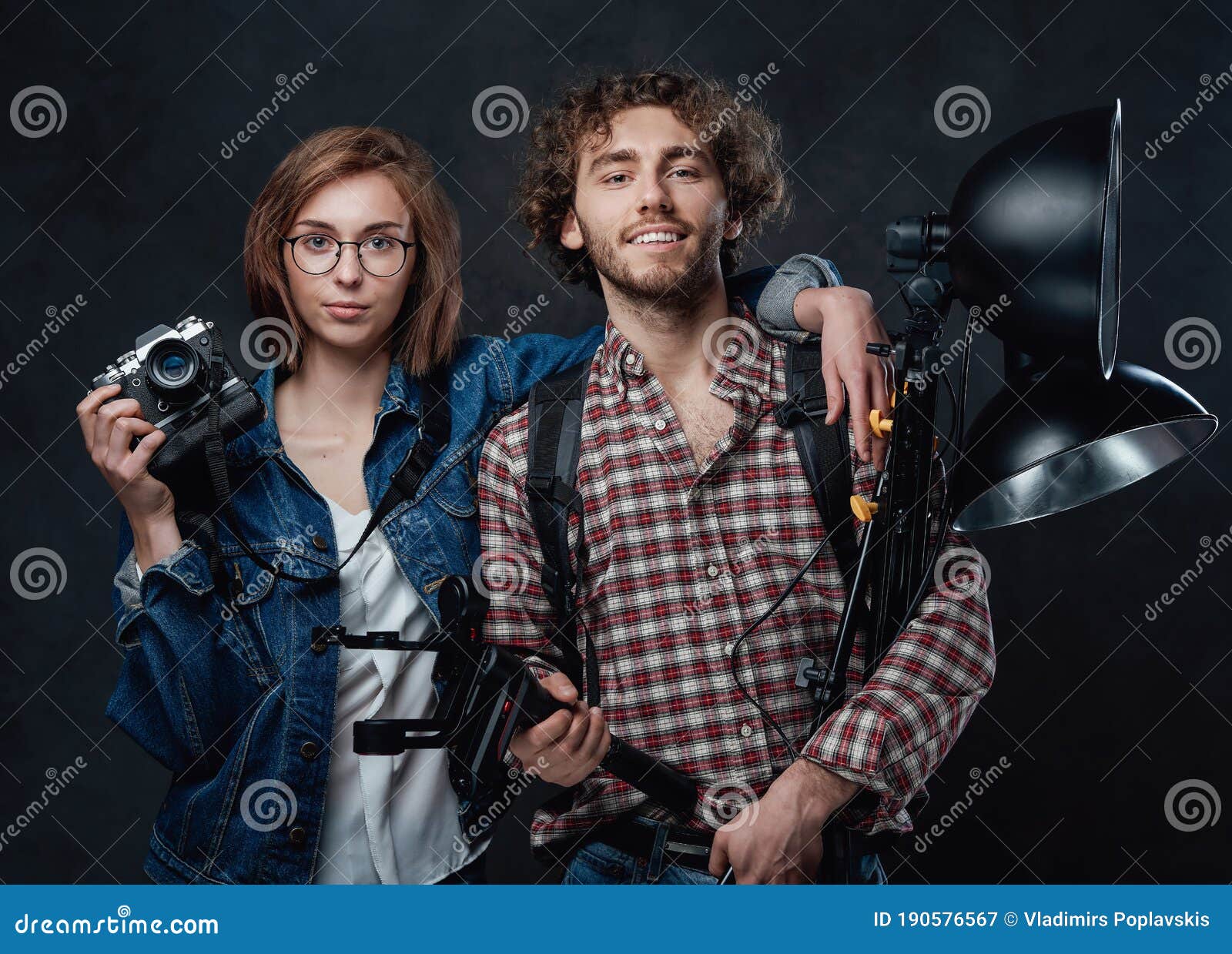 The Team of Two Young Photographers Holds a Digital Camera and Lighting ...