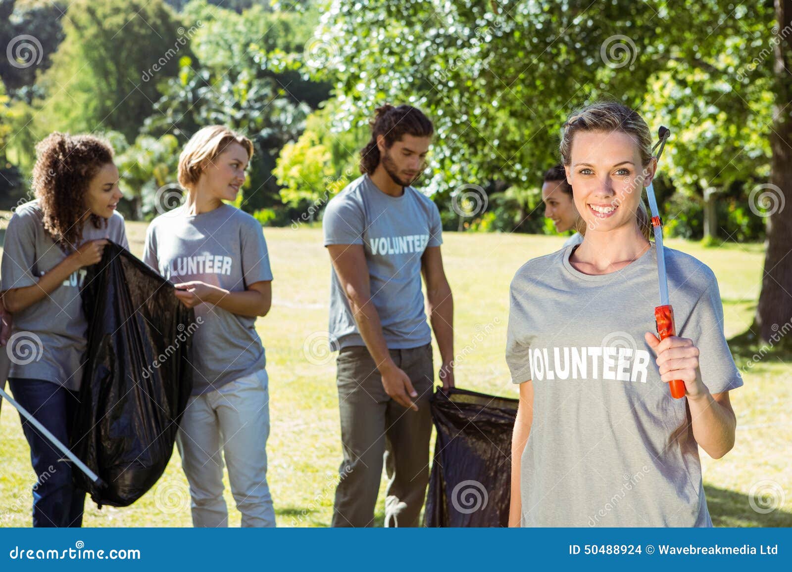 Team of Volunteers Picking Up Trash Stock Photo - Image of male ...