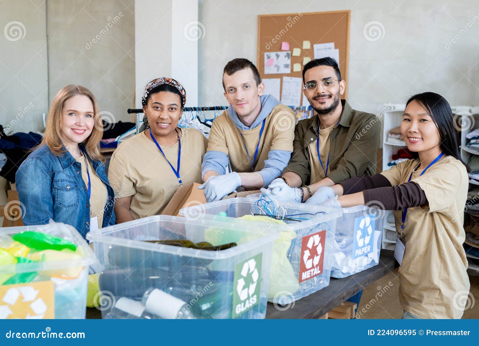 Team of Volunteers Standing by Table with Plastic Containers Stock ...