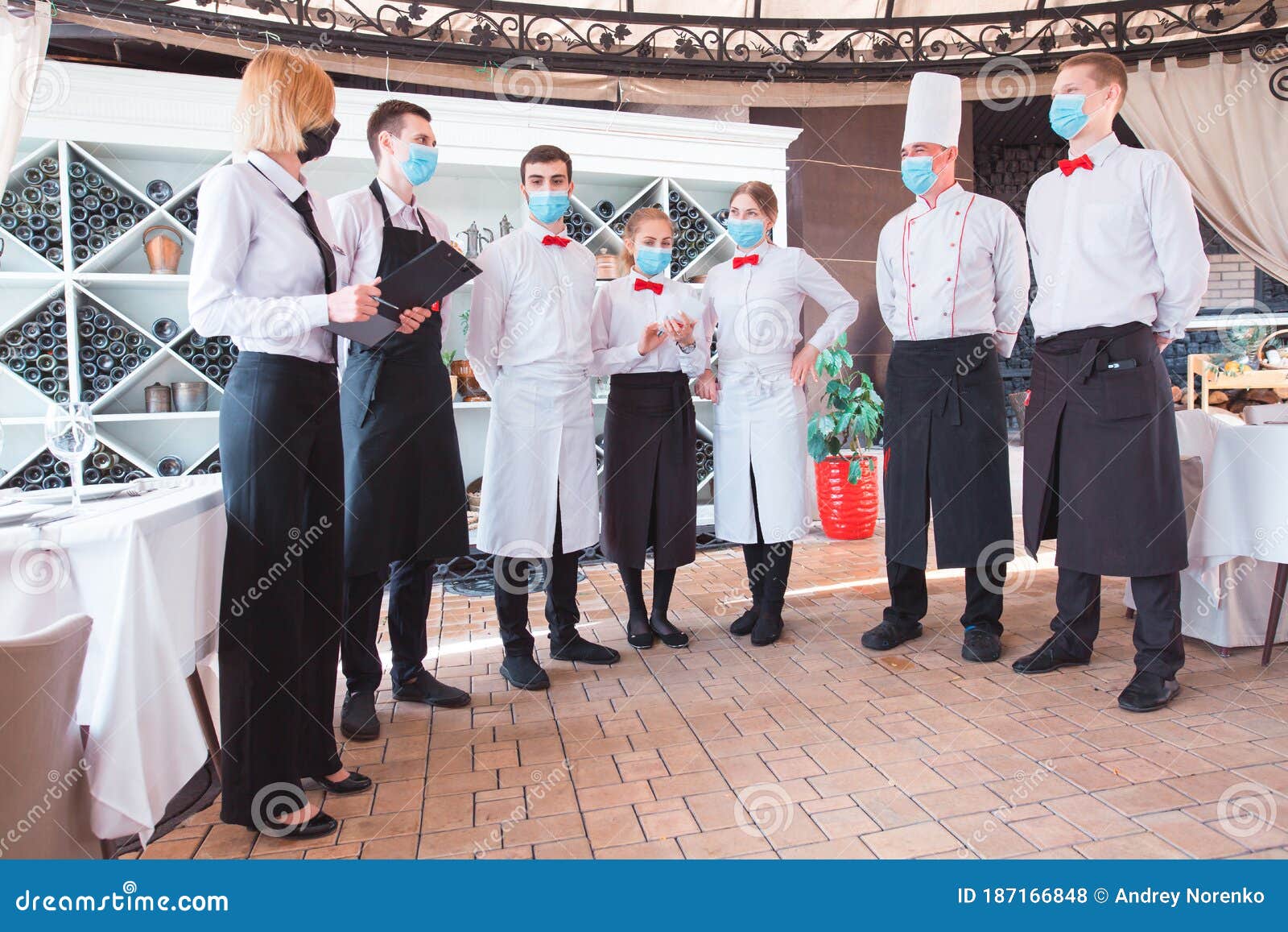 A Team of Waiters Conduct a Briefing on the Summer Terrace of the ...