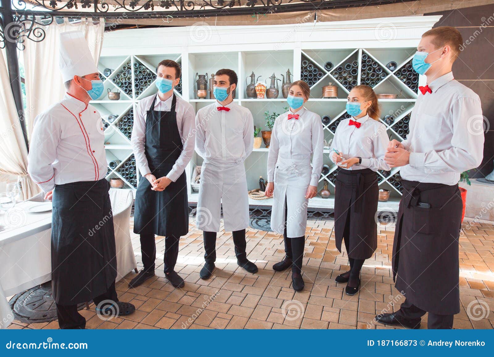 A Team of Waiters Conduct a Briefing on the Summer Terrace of the ...