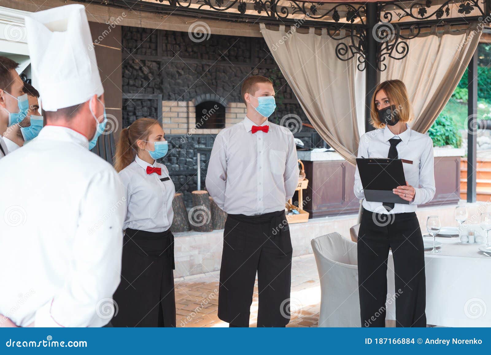 A Team of Waiters Conduct a Briefing on the Summer Terrace of the ...