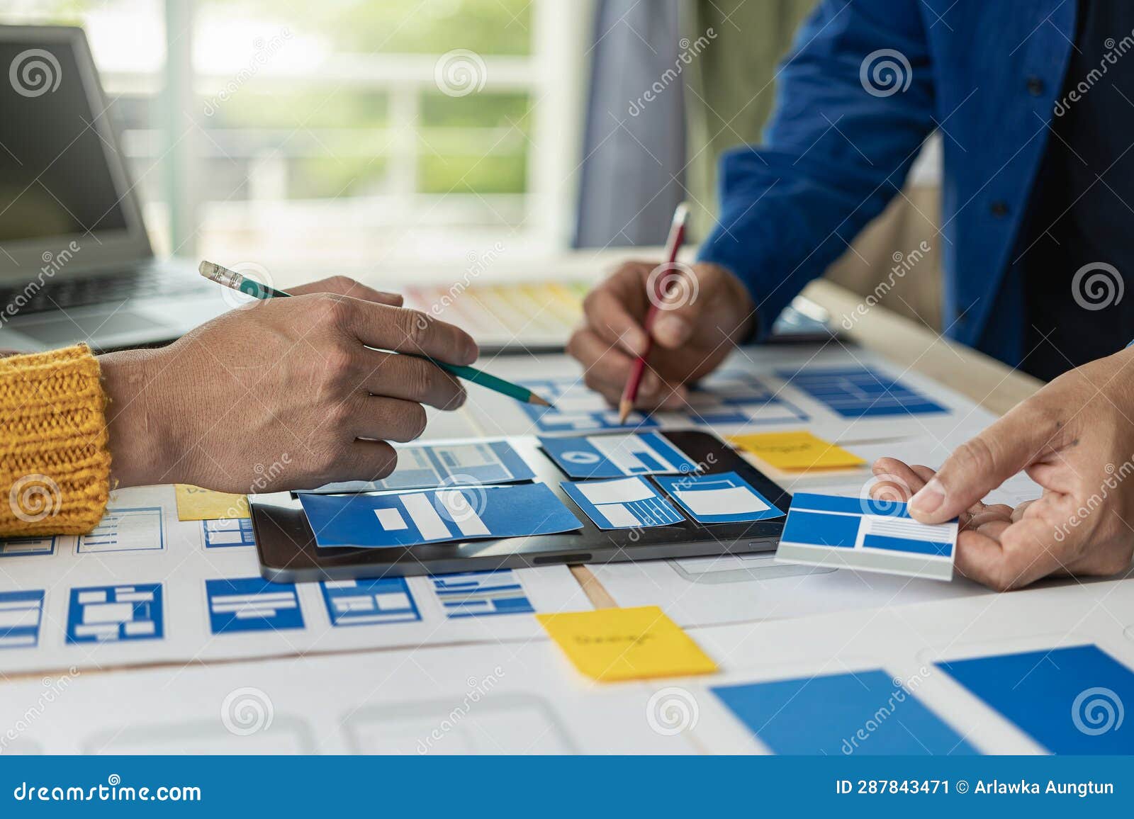 A Team of Web Designers are Working Together To Develop a Mobile ...