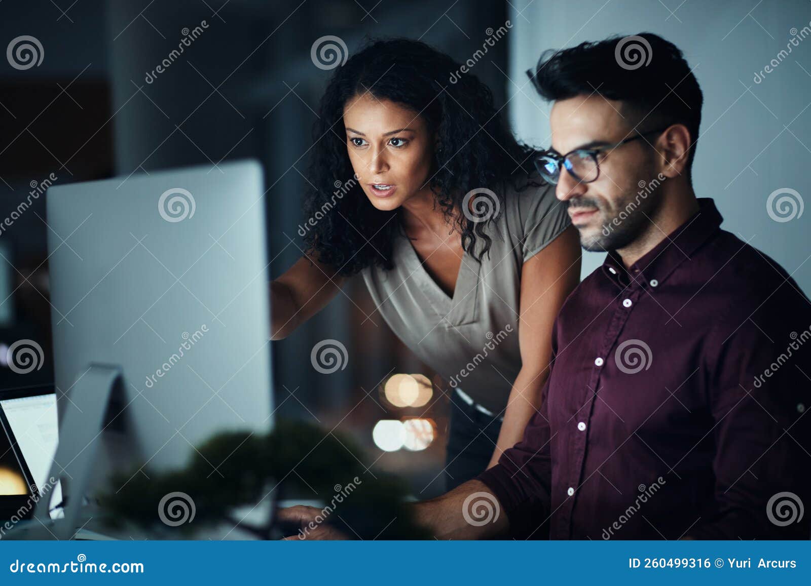 The Team that Wont Stop until Its Done. Two Colleagues Using a Computer Together during a Late ...