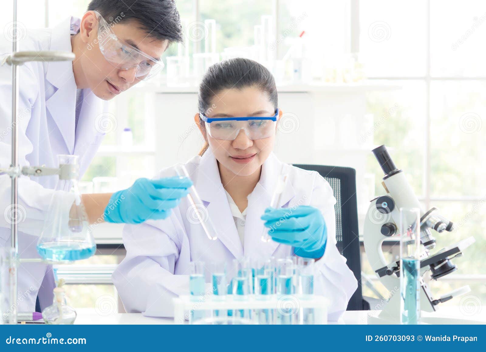 Team Work Asian Woman and Man Scientists Analyzing Study Data and ...