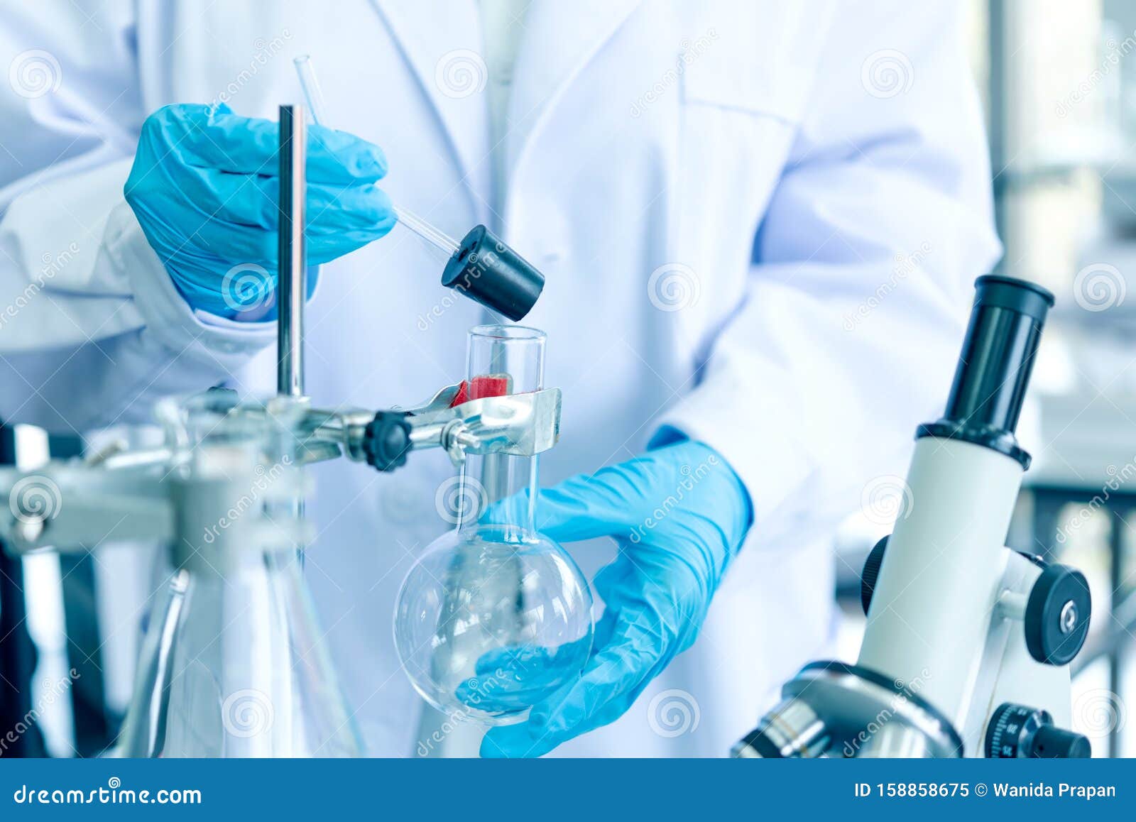 Scientists Analyzing Study Data And Evaluating Microscope. Health Care ...