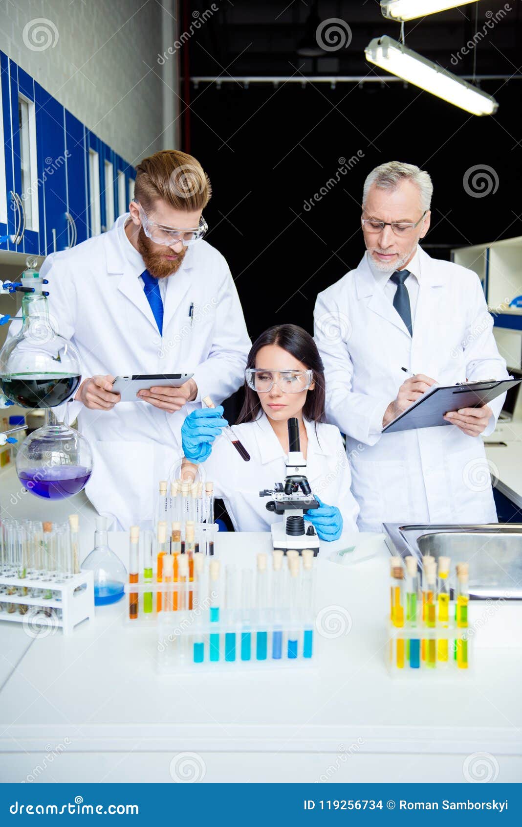 Team Work of Three. Group of Scientists are Working for Invent T Stock ...