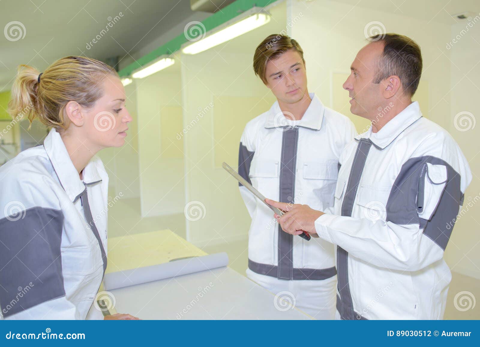 Team Workers in Matching Uniforms Stock Photo - Image of male, tools ...