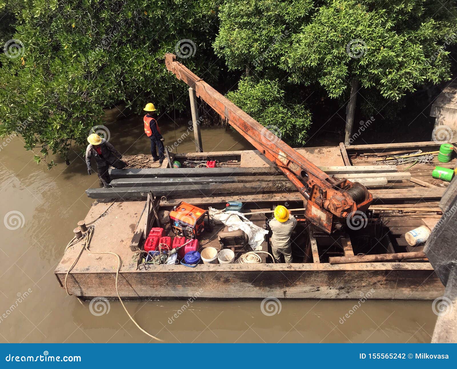 Team of Workers Pull the Concrete Pillars Out of the Water Editorial ...