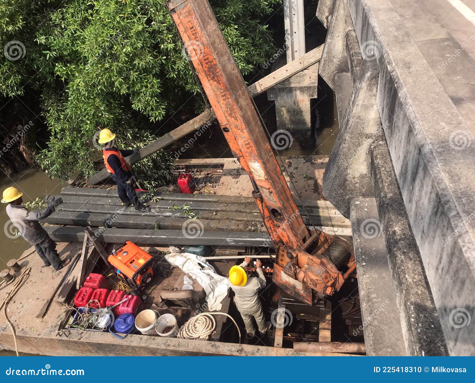 Team of Workers Pull the Concrete Pillars Out of the Water Stock Photo ...