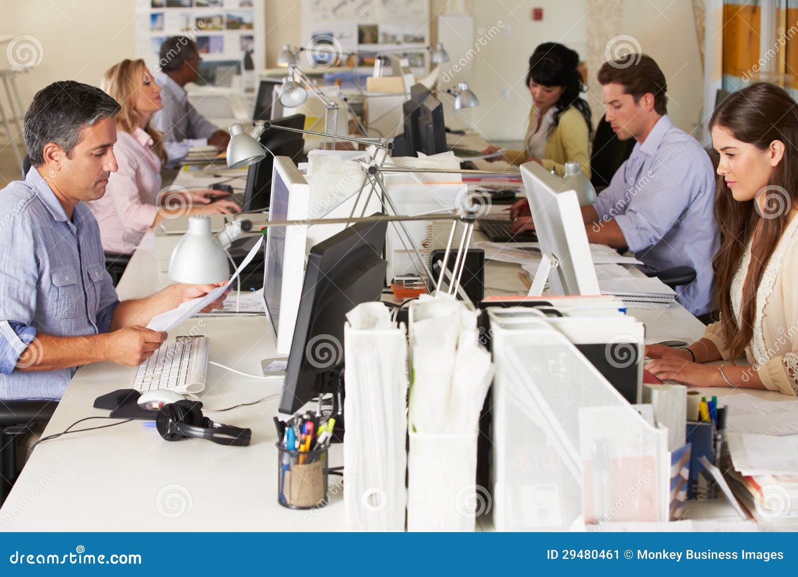 Team Working at Desks in Busy Office Stock Image - Image of group ...