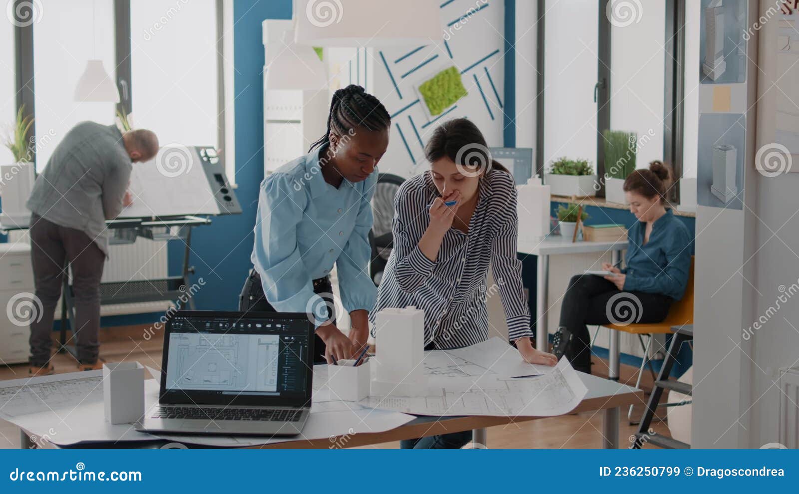 Team of Workmates Looking at Building Model and Blueprints Plans on ...