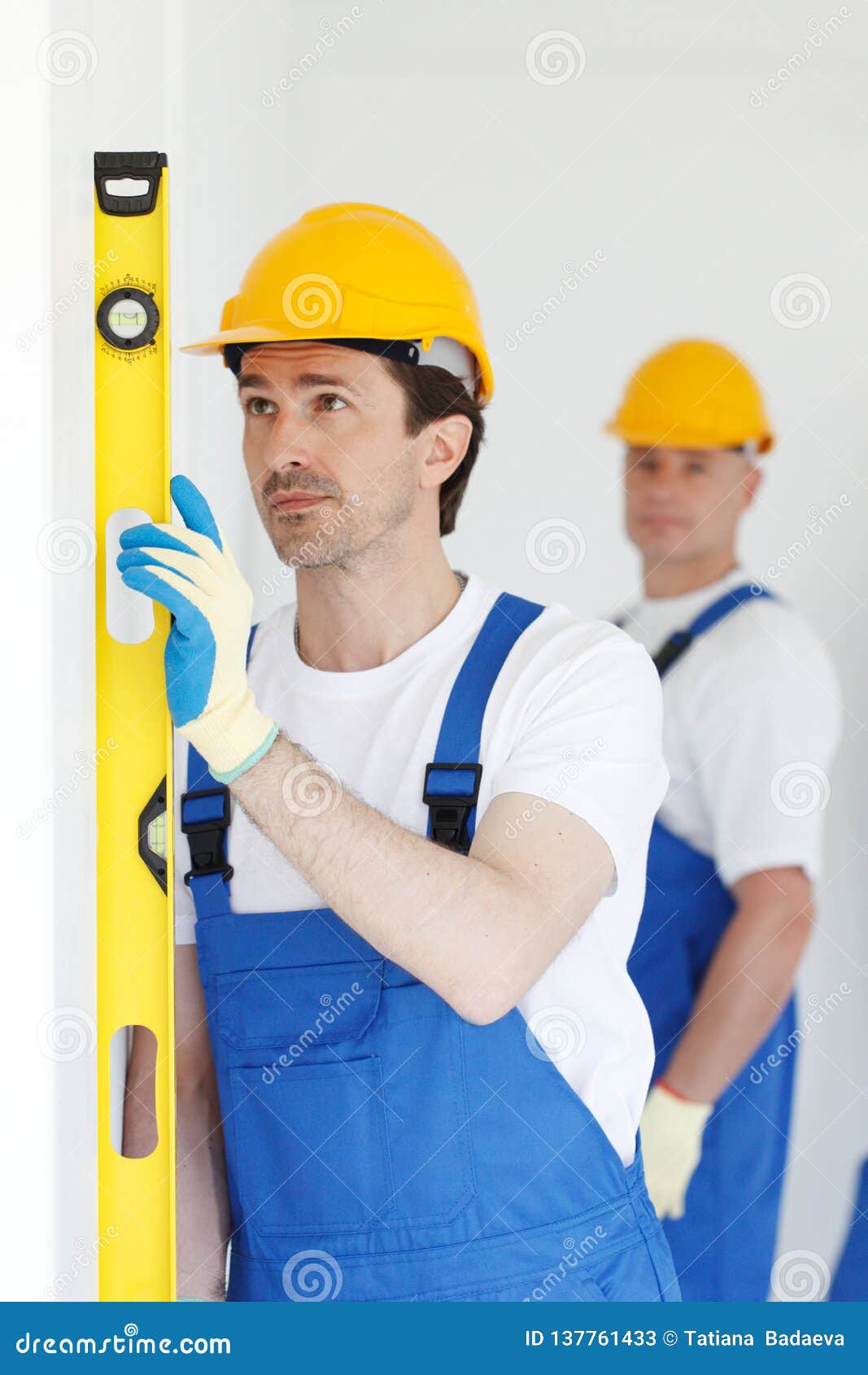 Team of workmen align wall stock image. Image of occupation - 137761433