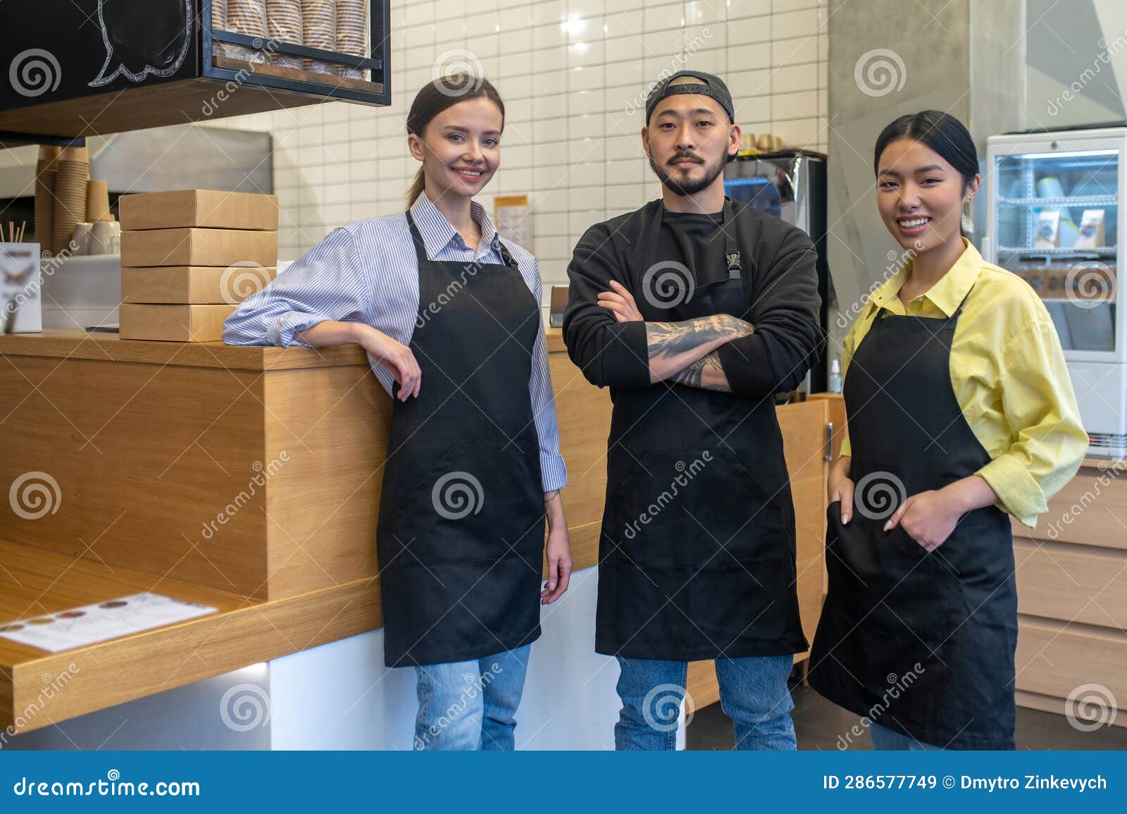 Team of Young Cafe Workers Standing Together and Looking Contented ...