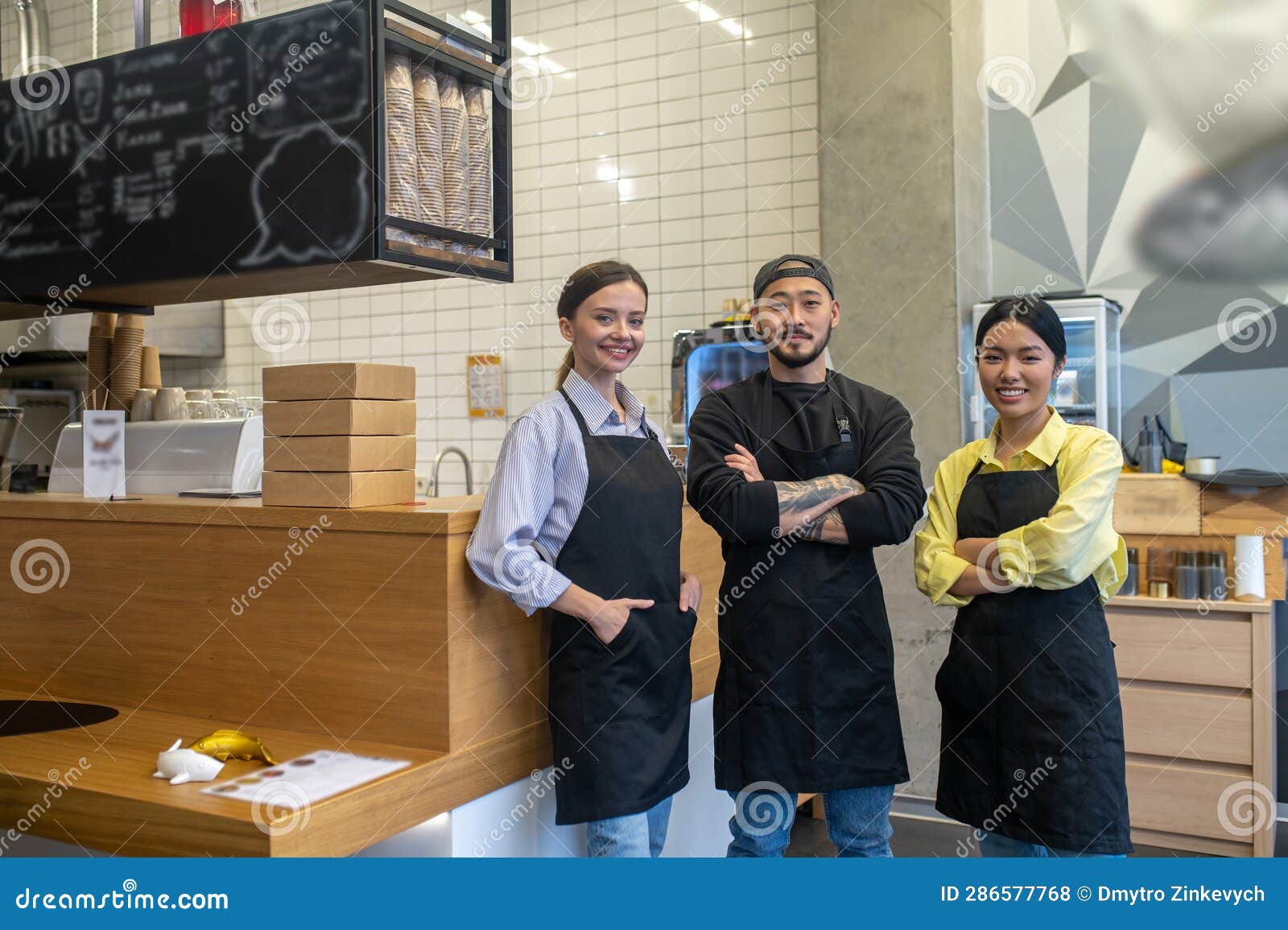 Team of Young Cafe Workers Standing Together and Looking Contented ...