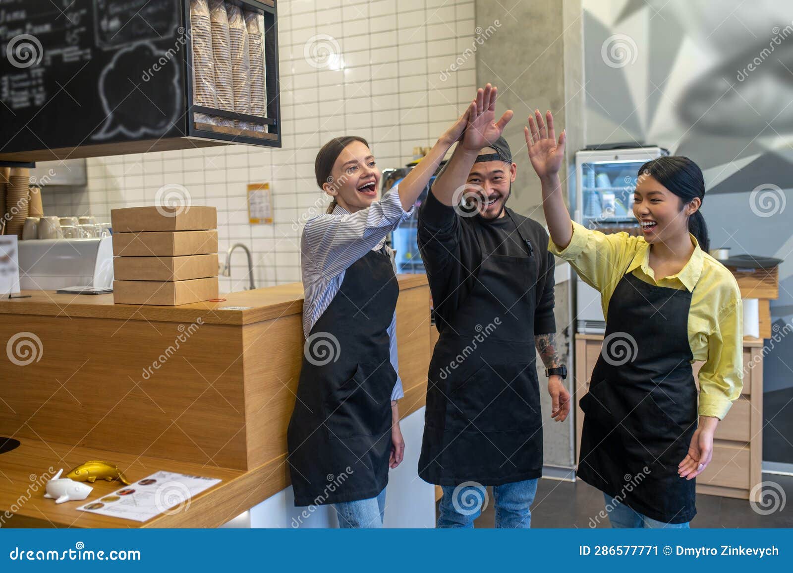 Team of Young Cafe Workers Standing Together and Looking Contented ...