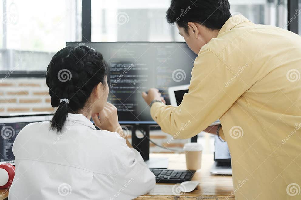 Team of Young Computer Programmers Cooperating while Working on Desktop ...