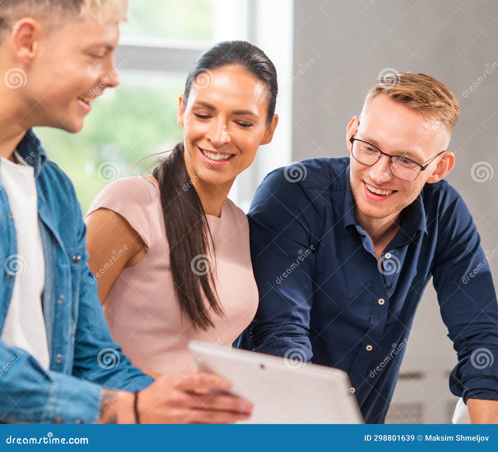 Team of Young and Confident Startupers is Working at the Table in the Office, Discussing the ...