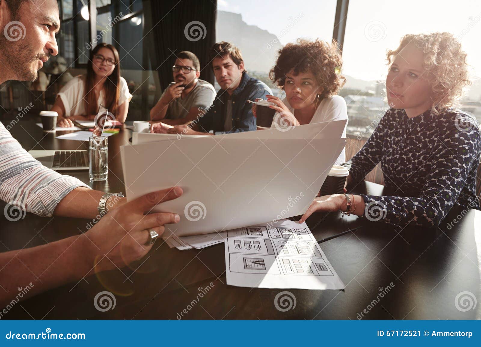 Team of Young People Going Over Paperwork Stock Image - Image of ...