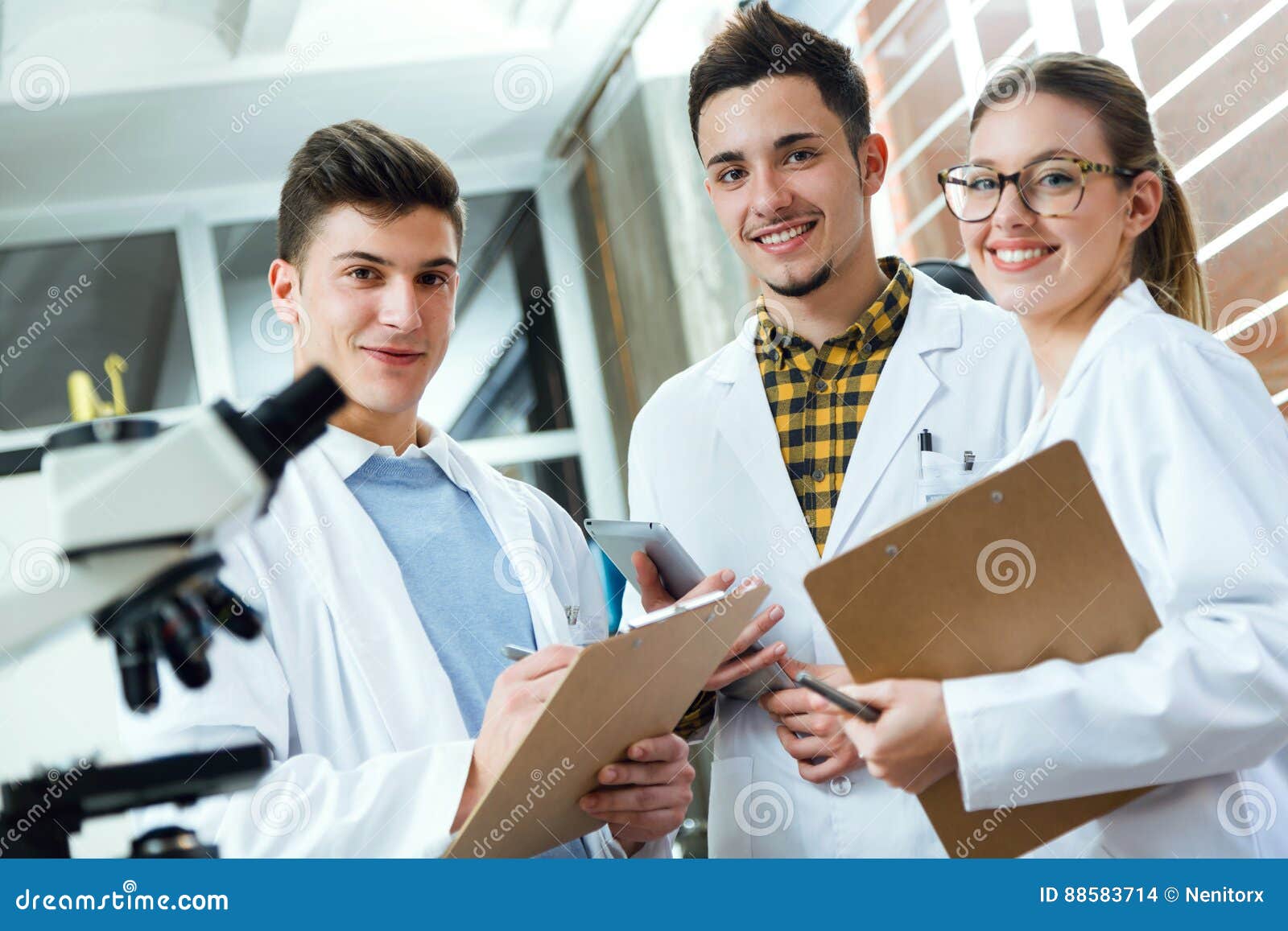 Team of Young Professional Scientists Looking at Camera in Labor Stock ...