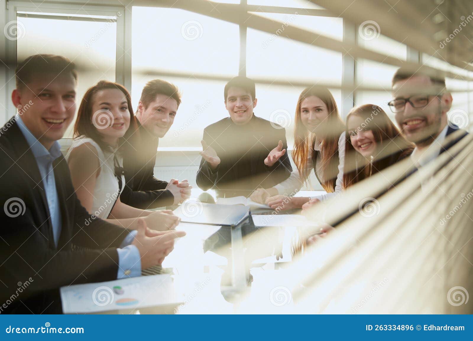 Team of Young Professionals Sitting at an Office Desk. Stock Photo ...