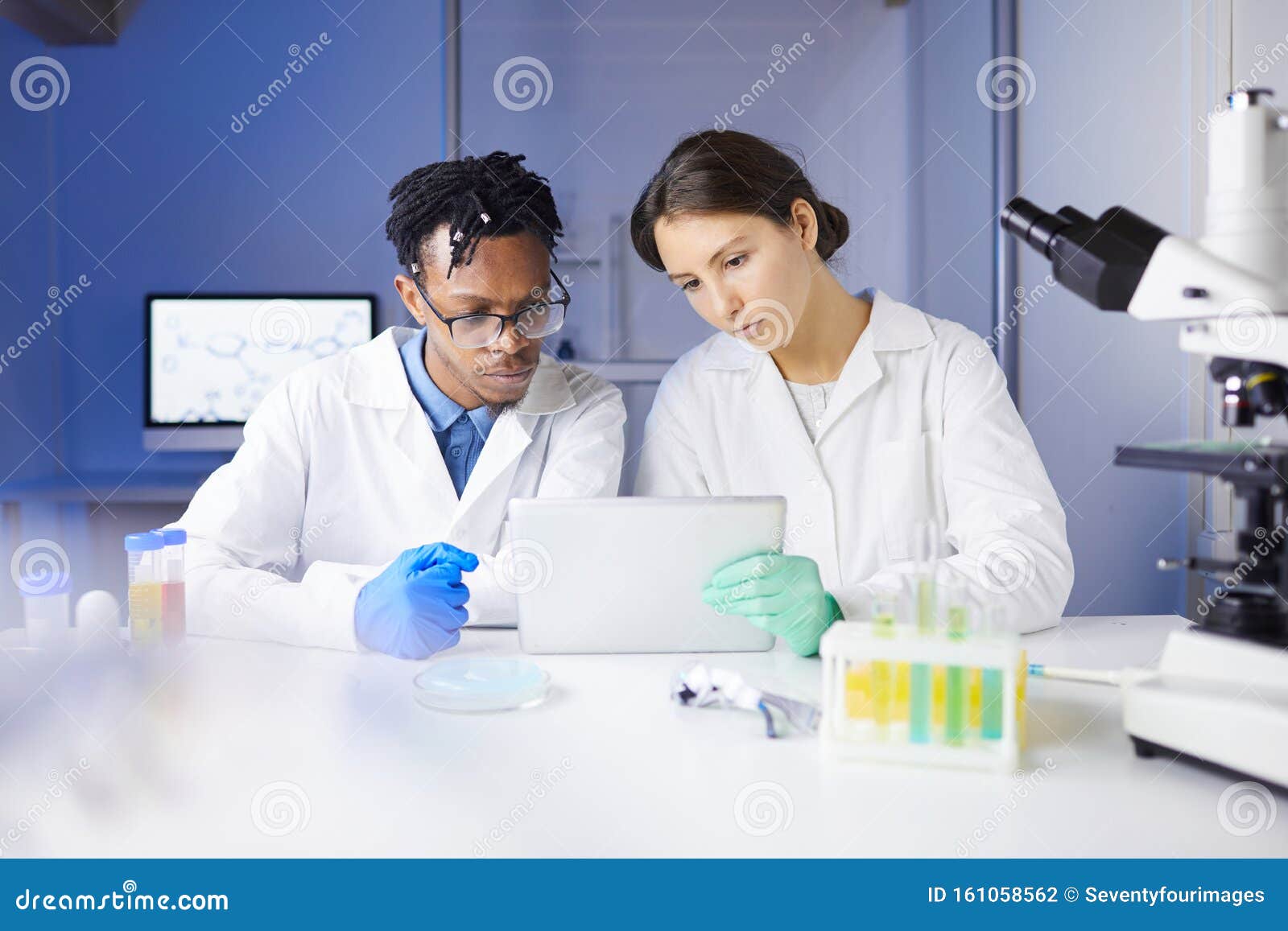Team of Young Scientists Working in Laboratory Stock Photo - Image of ...