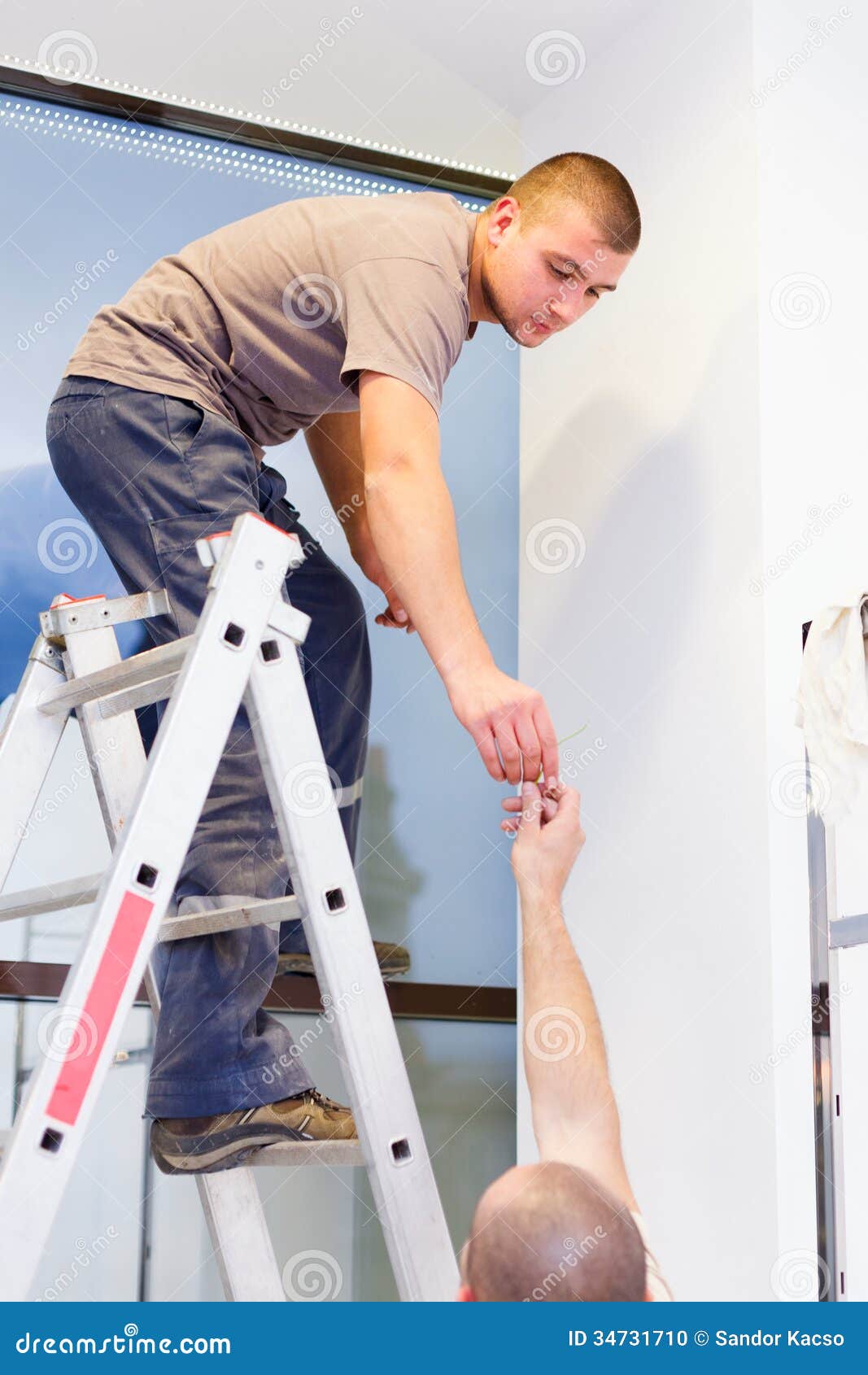 Teammates Helping Each Other Stock Photo - Image of handyman ...