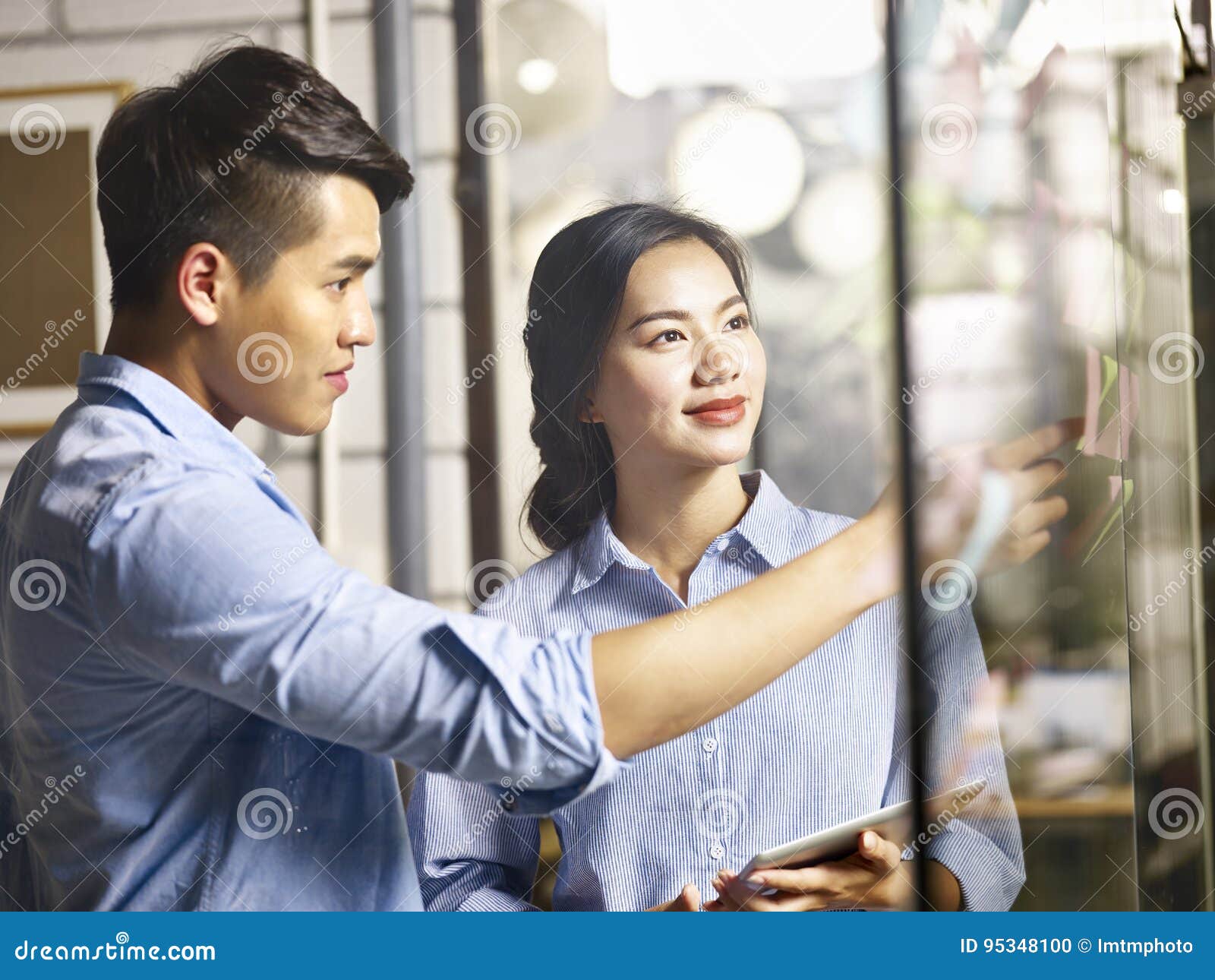 Teammates working together stock photo. Image of corporate - 95348100