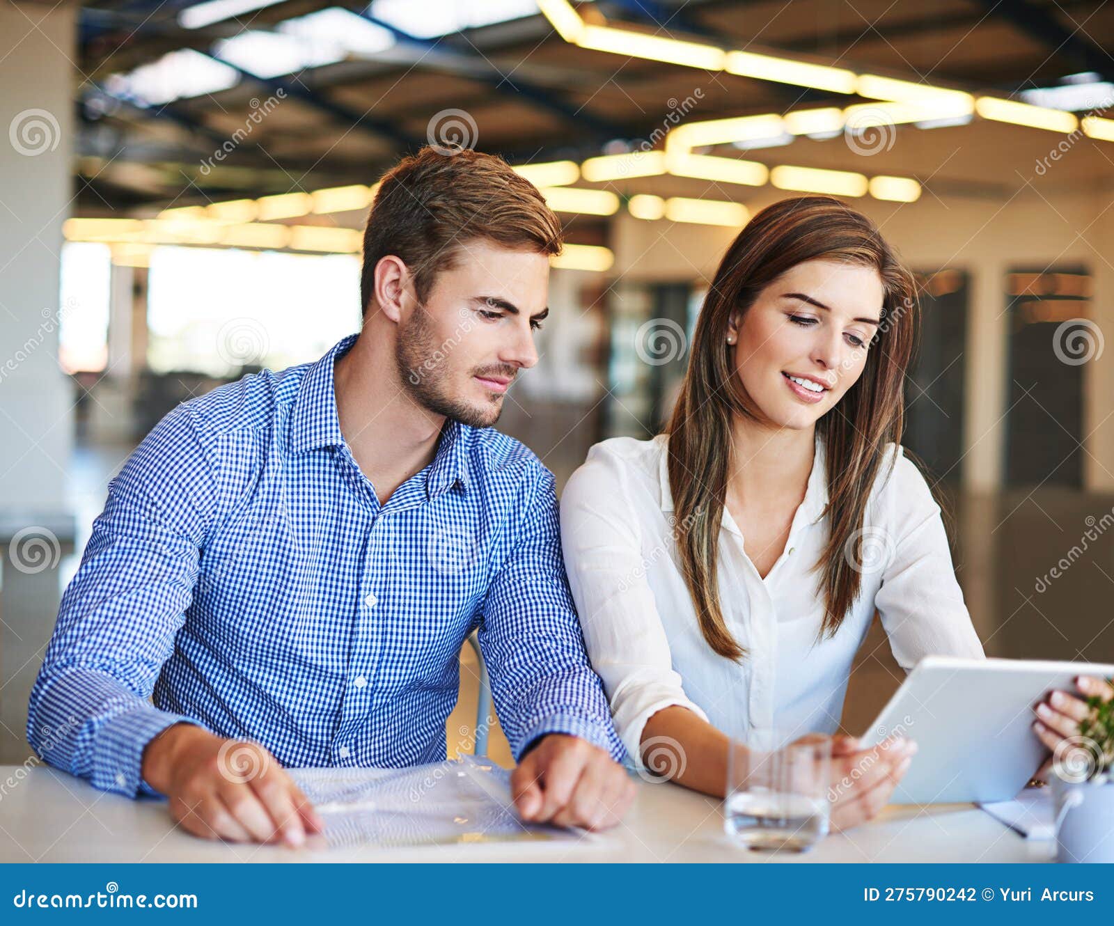 Teamwork in Action. Two Colleagues Working Together on a Digital Tablet ...
