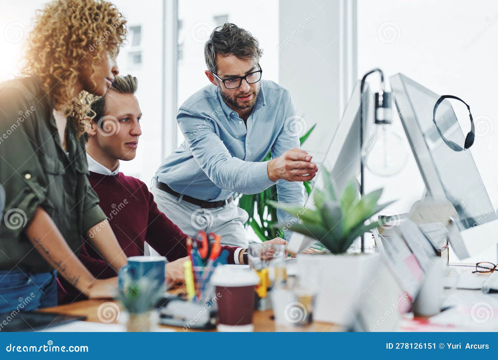Teamwork is always the Answer. a Group of Colleagues Using a Computer ...