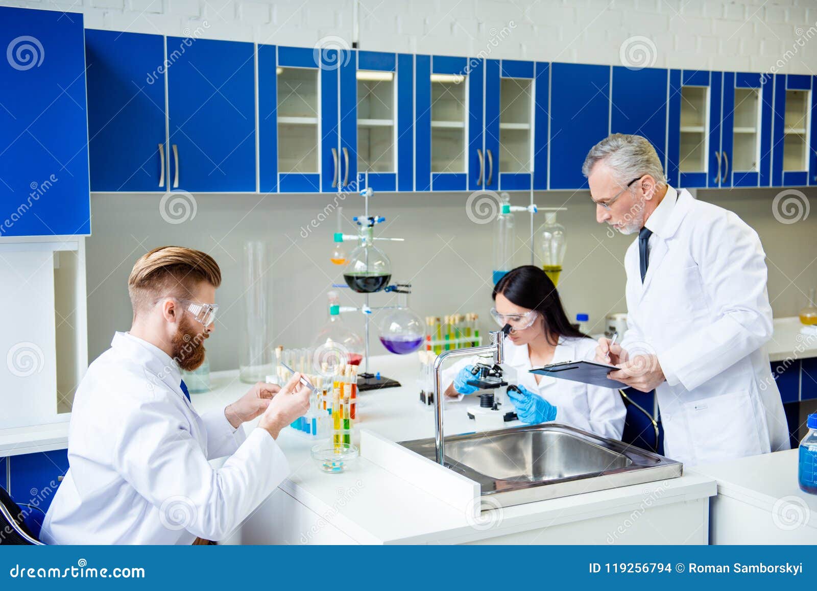 Teamwork Concept. Professor is Checking and Controlling the Group Work ...