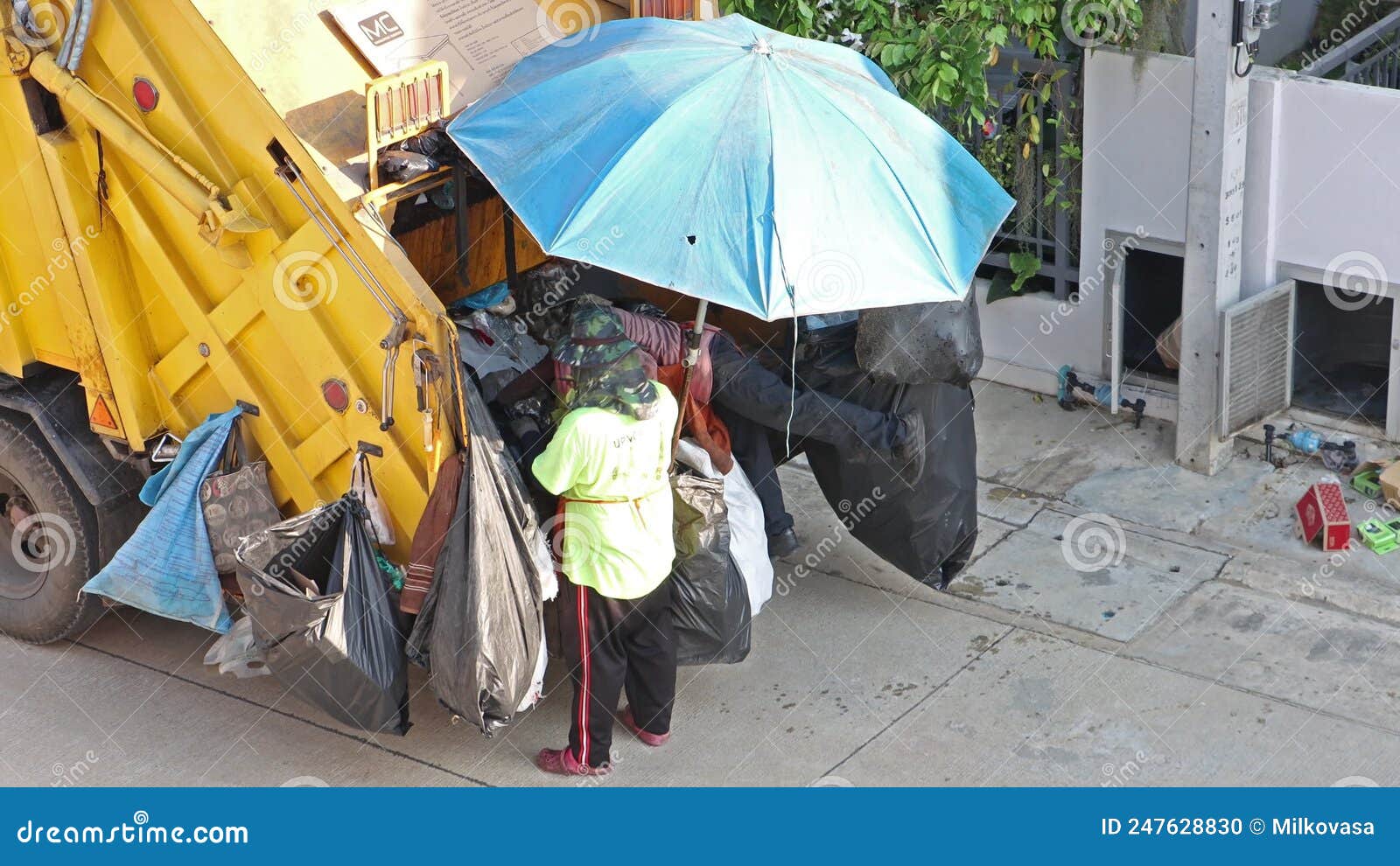 Teamwork of Garbage Men when Loading Waste into the Garbage Truck Stock ...