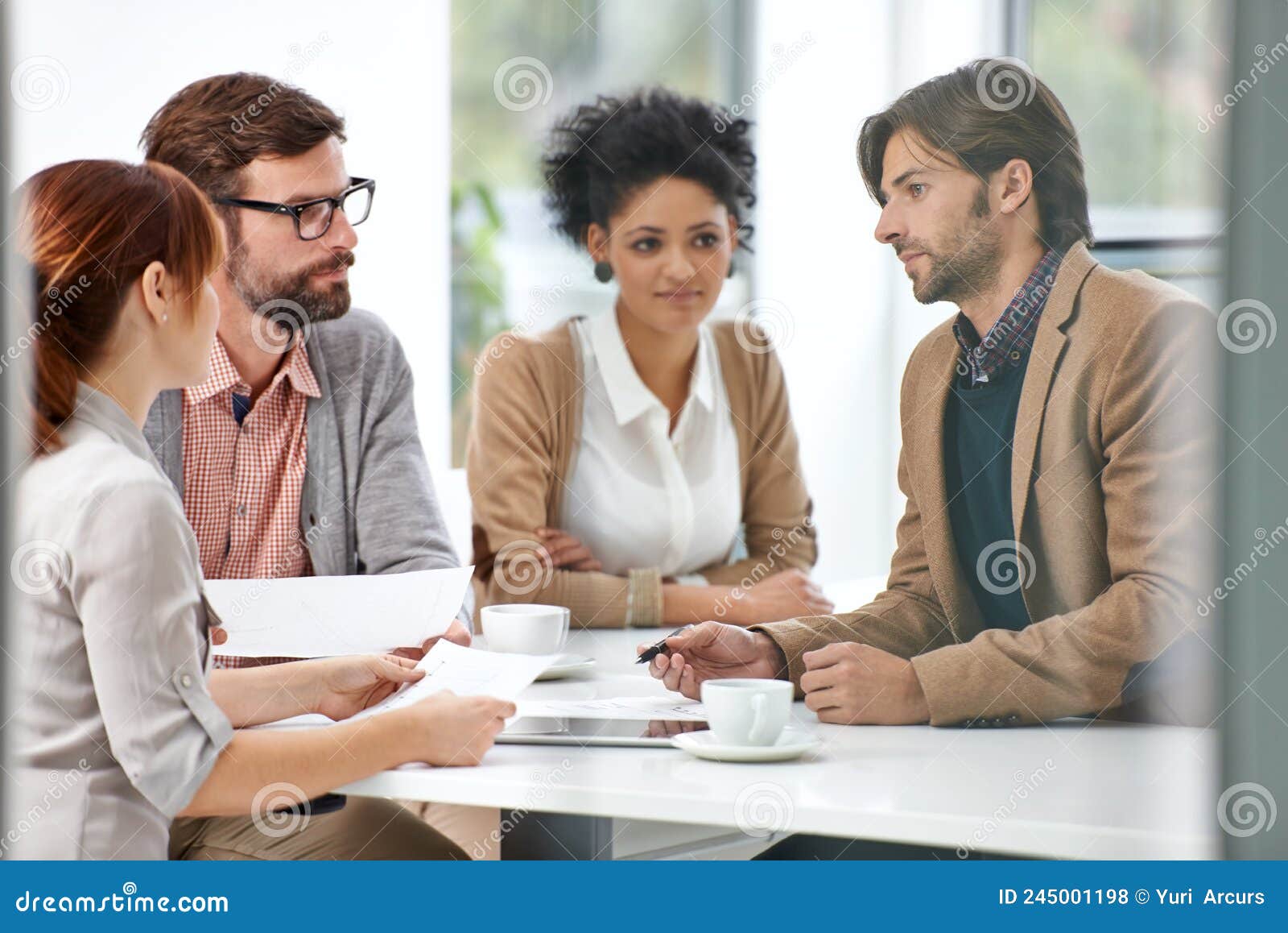 Teamwork Gets Business Done. a Group of Businesspeople Going Over Some ...