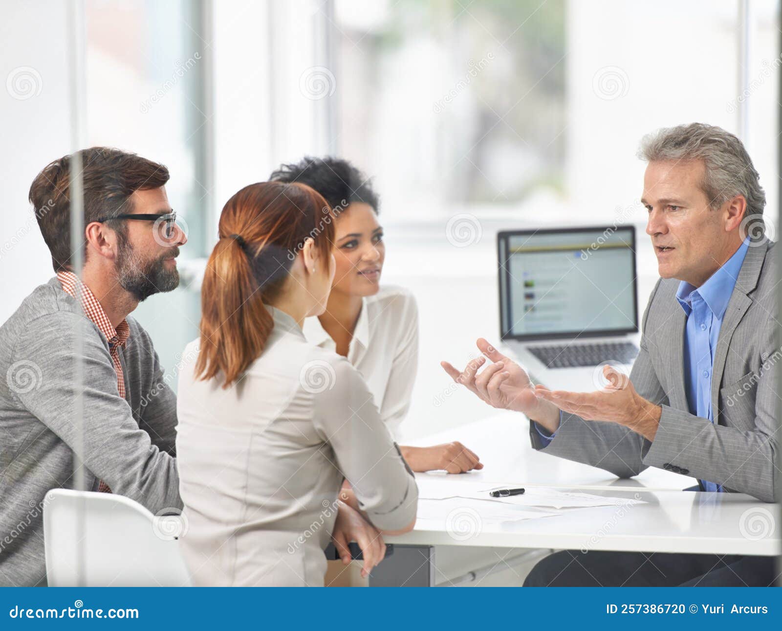 Teamwork Gets Business Done. a Group of Businesspeople Going Over Some ...