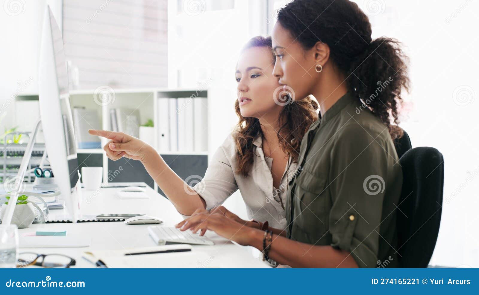 Teamwork Gets Results. Two Young Businesswomen Using a Computer ...